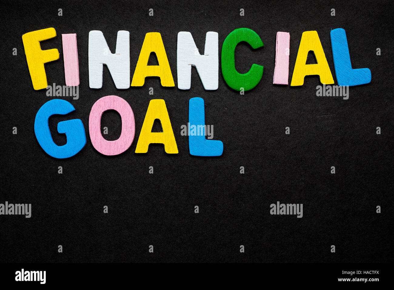 Colorful wooden letters forming the phrase "financial goal Stock Photo ...