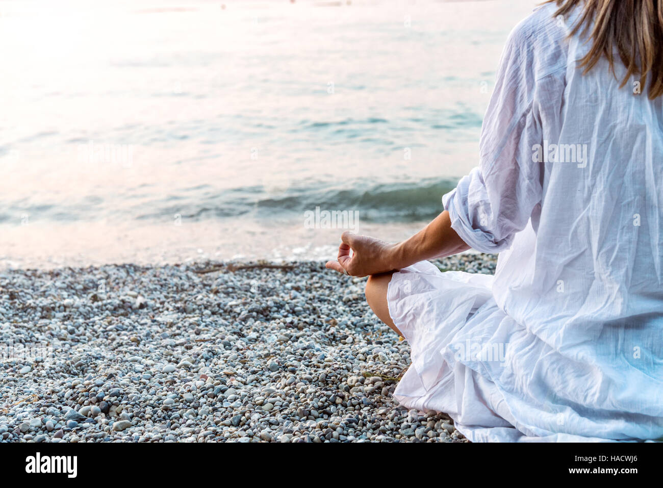 Woman meditating at the sea Stock Photo - Alamy