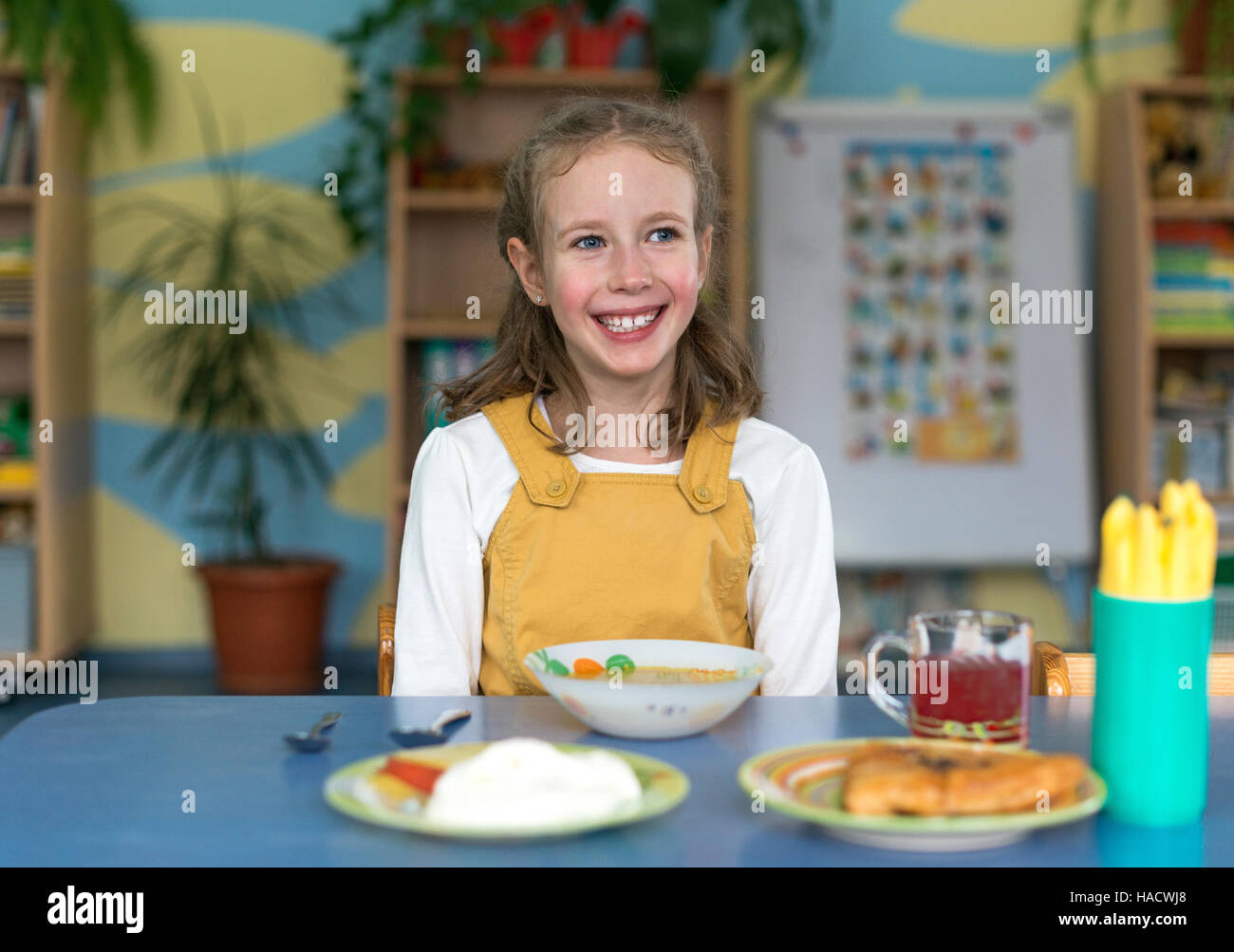 Little girl before lunch in kindergarten Stock Photo - Alamy