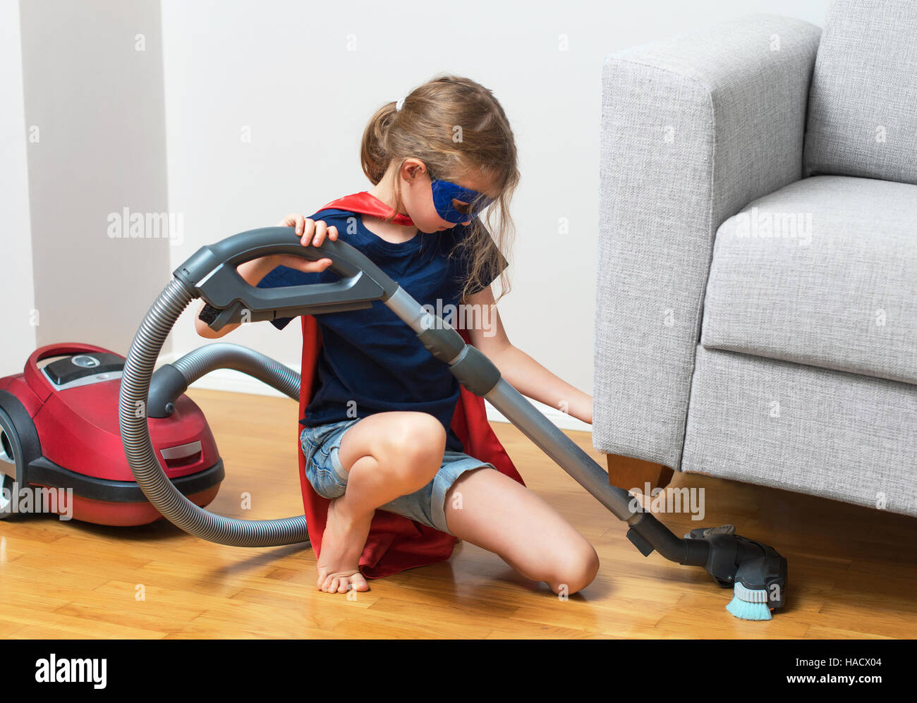 Super hero kid with vacuum cleaner Stock Photo - Alamy