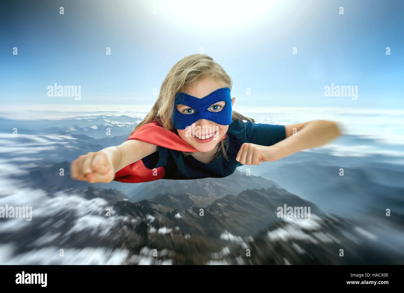 Superhero kid flying across the planet Stock Photo - Alamy