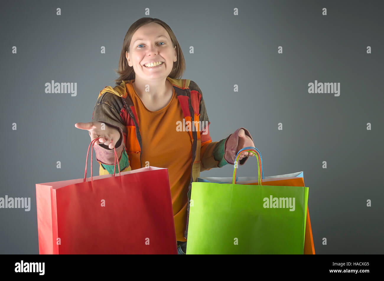 Shopping woman holding shopping bags. Female model isolated studio ...