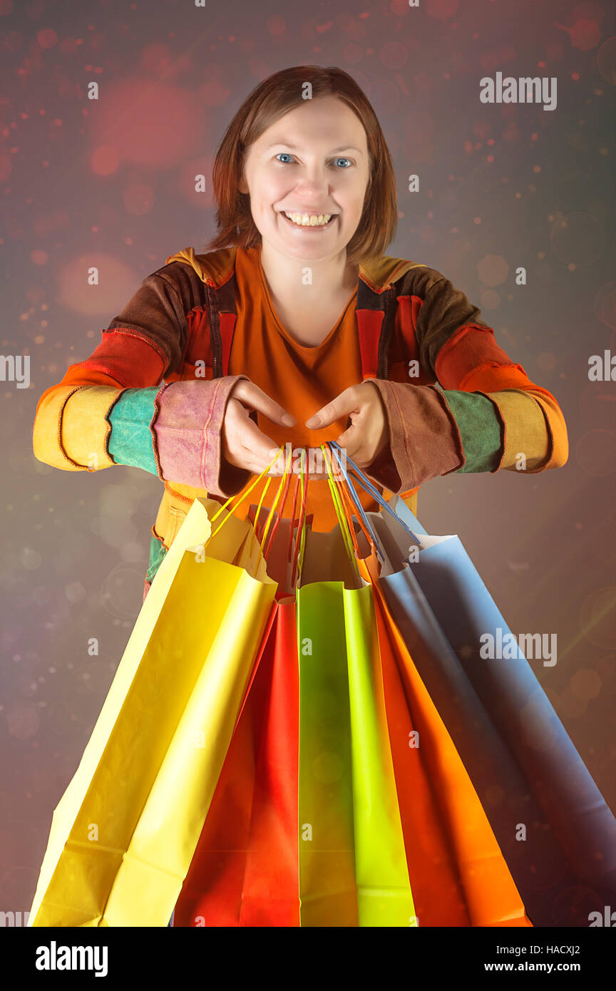 Shopping woman holding shopping bags. Female model isolated studio ...