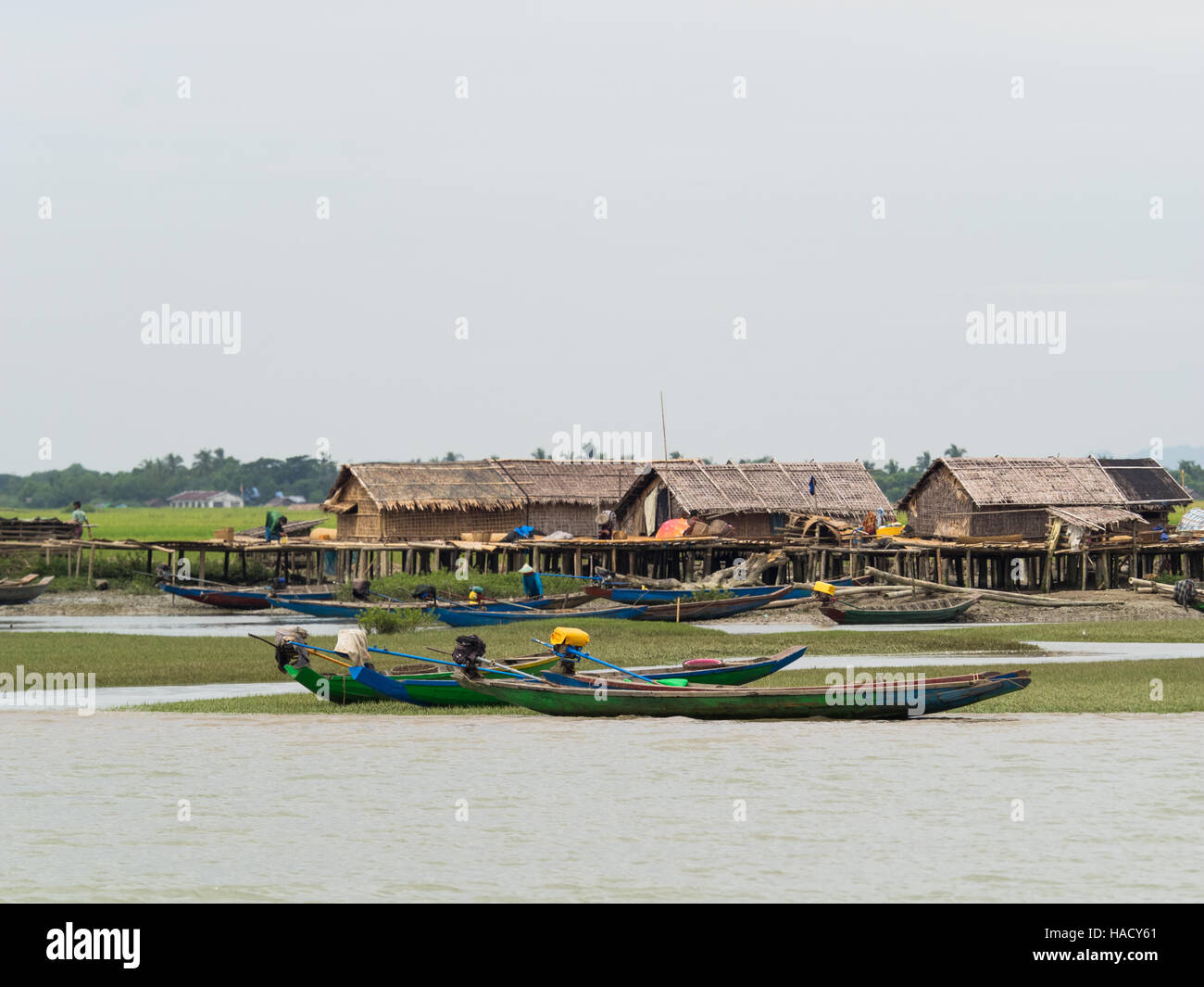 Fishing village and boats at the banks of Kaladan River in the Rakhine ...