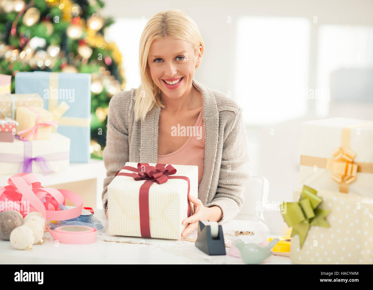 Beautiful woman wrapping Christmas presents Stock Photo - Alamy