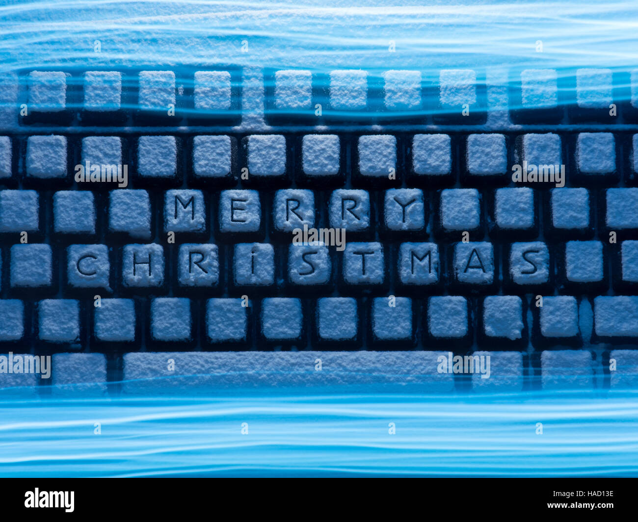 keyboard covered with snow with words Merry Christmas illuminated with ...
