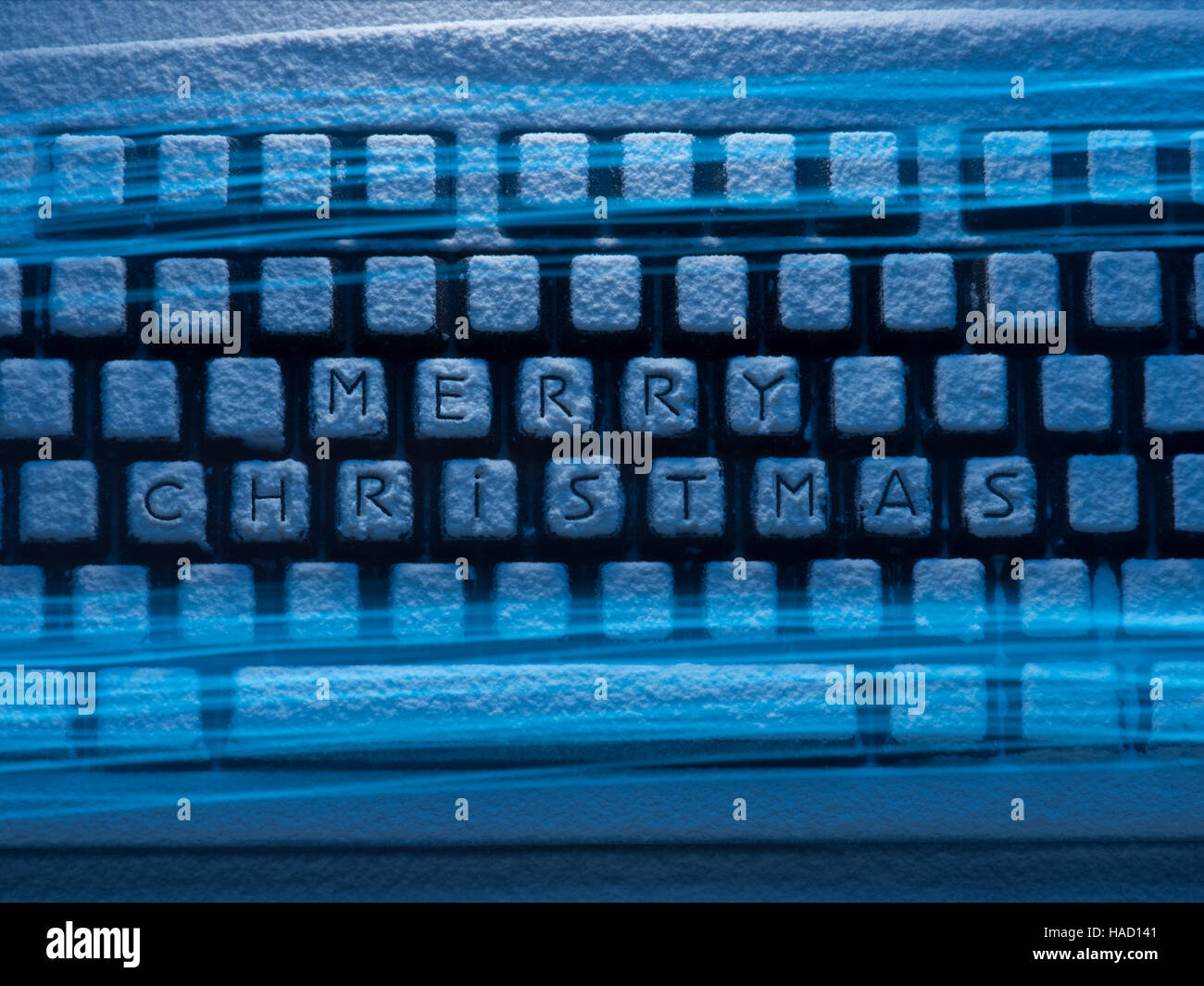 keyboard covered with snow with words Merry Christmas illuminated with ...
