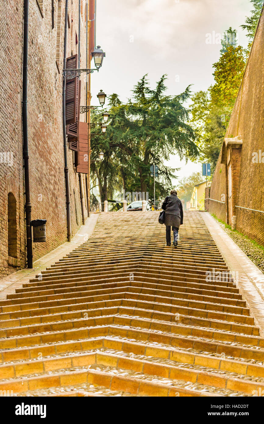 elderly woman walking on a stone staircase Stock Photo - Alamy
