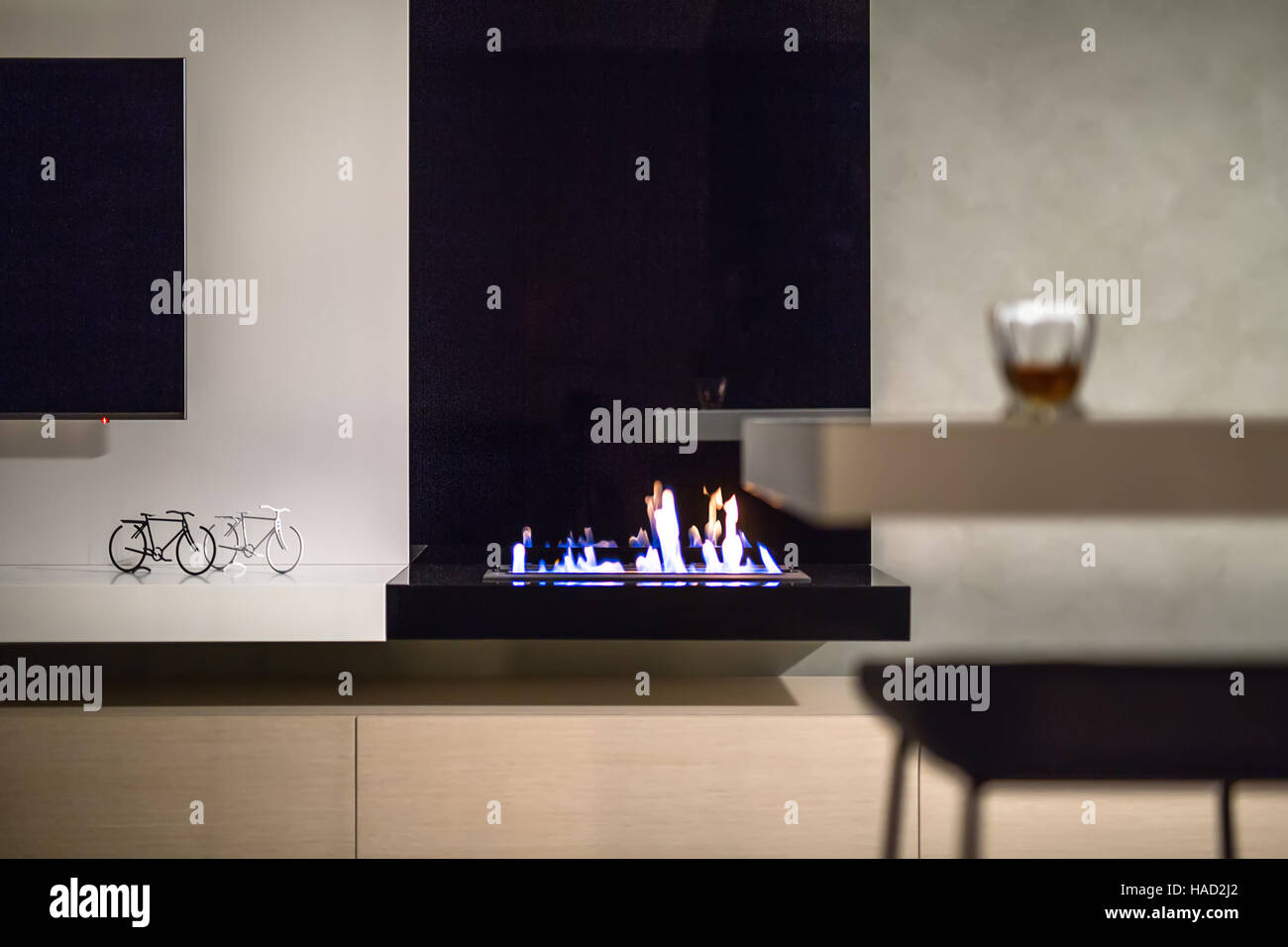 Burning fireplace in modern interior Stock Photo - Alamy