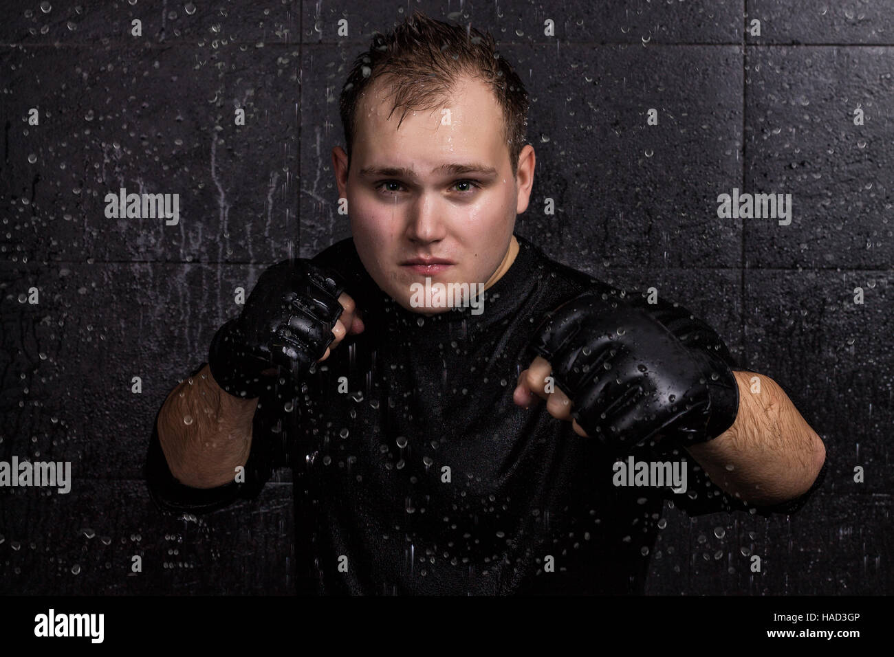 Portrait of boxer fighting in the rain in aquastudio with drops Stock ...