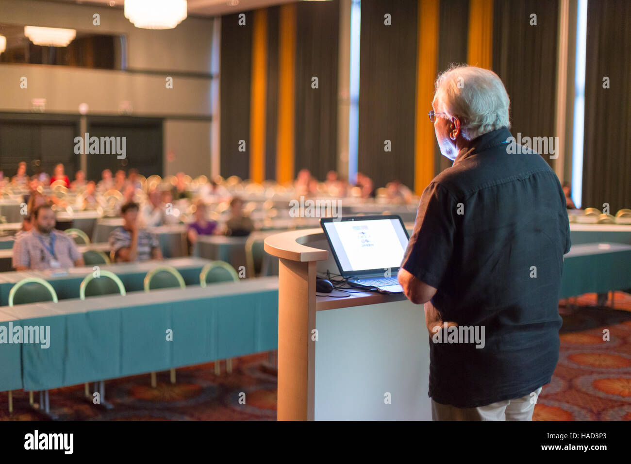 Senior public speaker giving talk at scientific conference Stock Photo ...