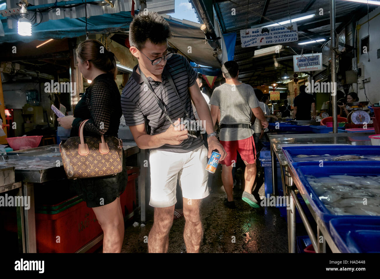 Photographer taking photo.Young man using "shooting from the hip ...