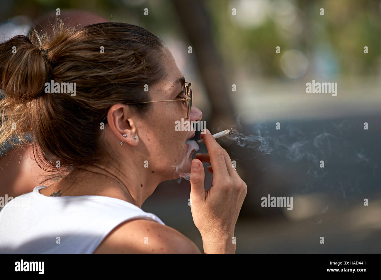 Woman smoking a cigarette Stock Photo - Alamy