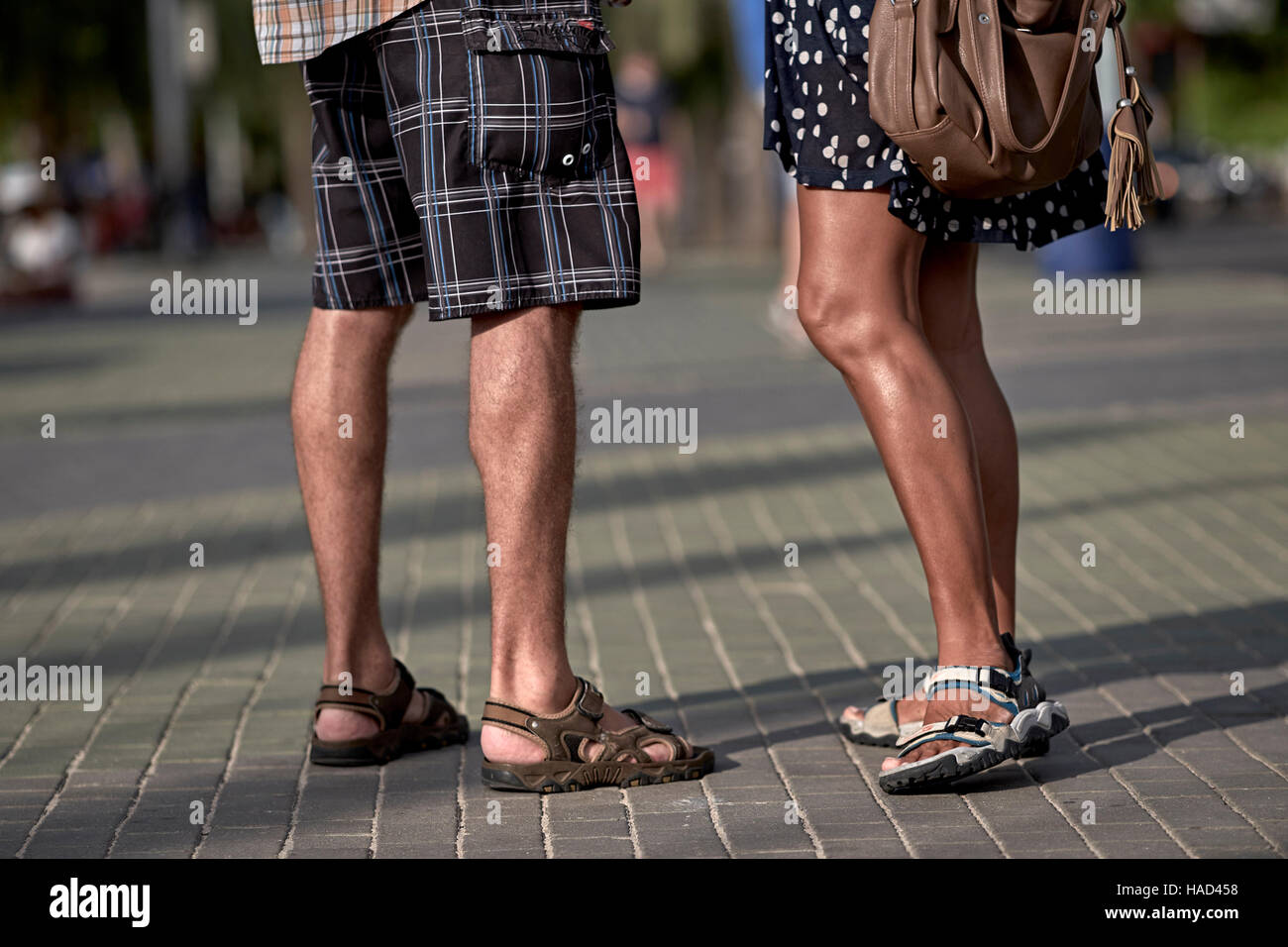 Closeup detail of a man and woman wearing sandals. Thailand S. E. Asia ...