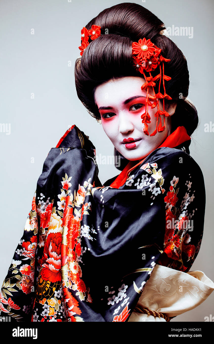 young pretty geisha in kimono on white background Stock Photo - Alamy