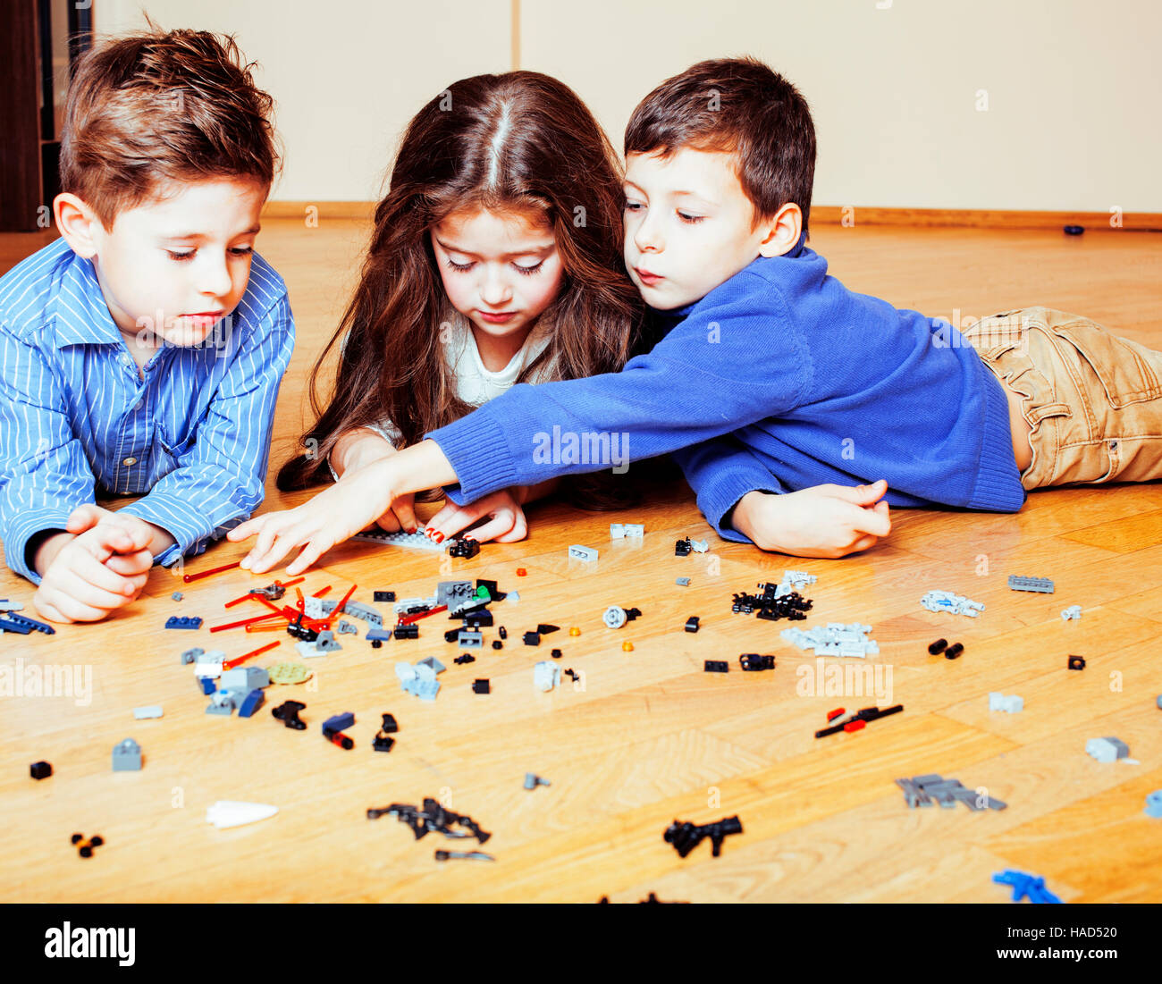 funny cute children playing lego at home, boys and girl smiling, first ...