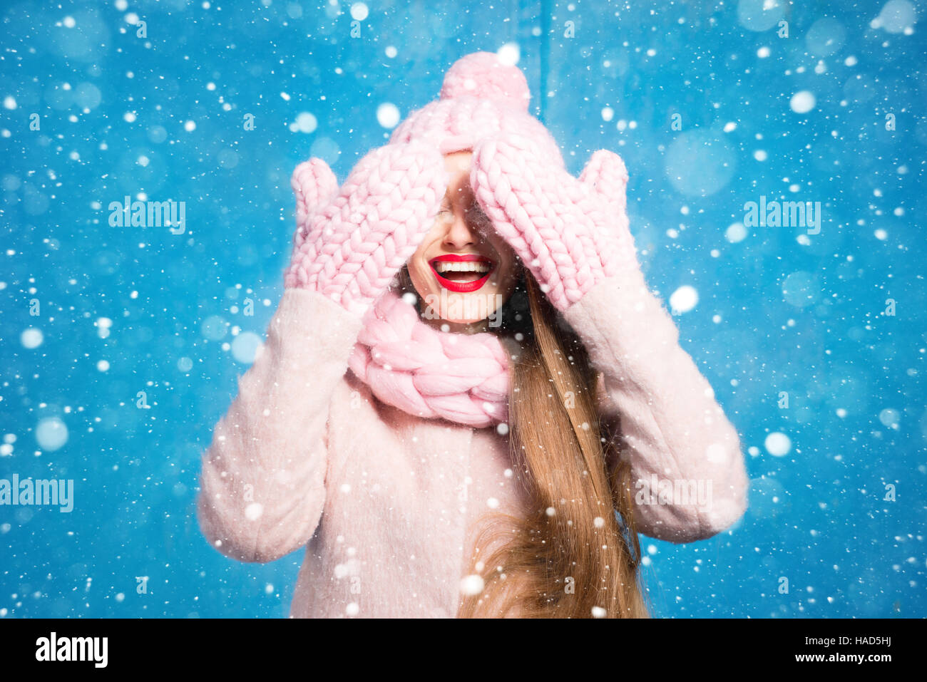 Winter woman portrait on the blue background Stock Photo - Alamy