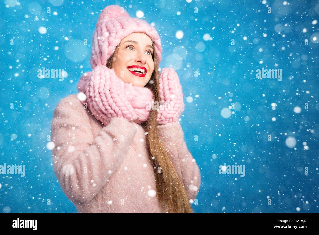 Winter woman portrait on the blue background Stock Photo - Alamy