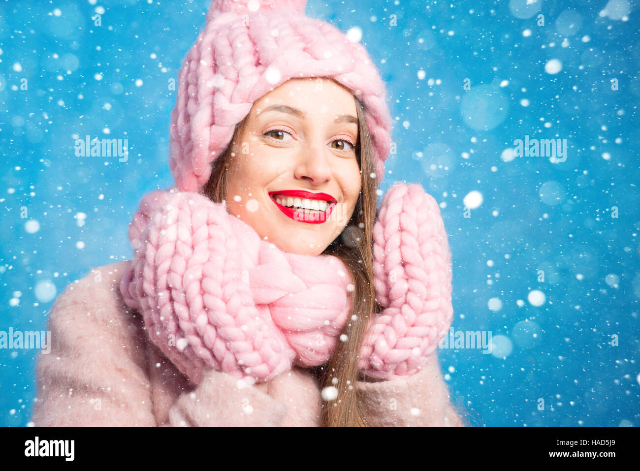Winter woman portrait on the blue background Stock Photo - Alamy
