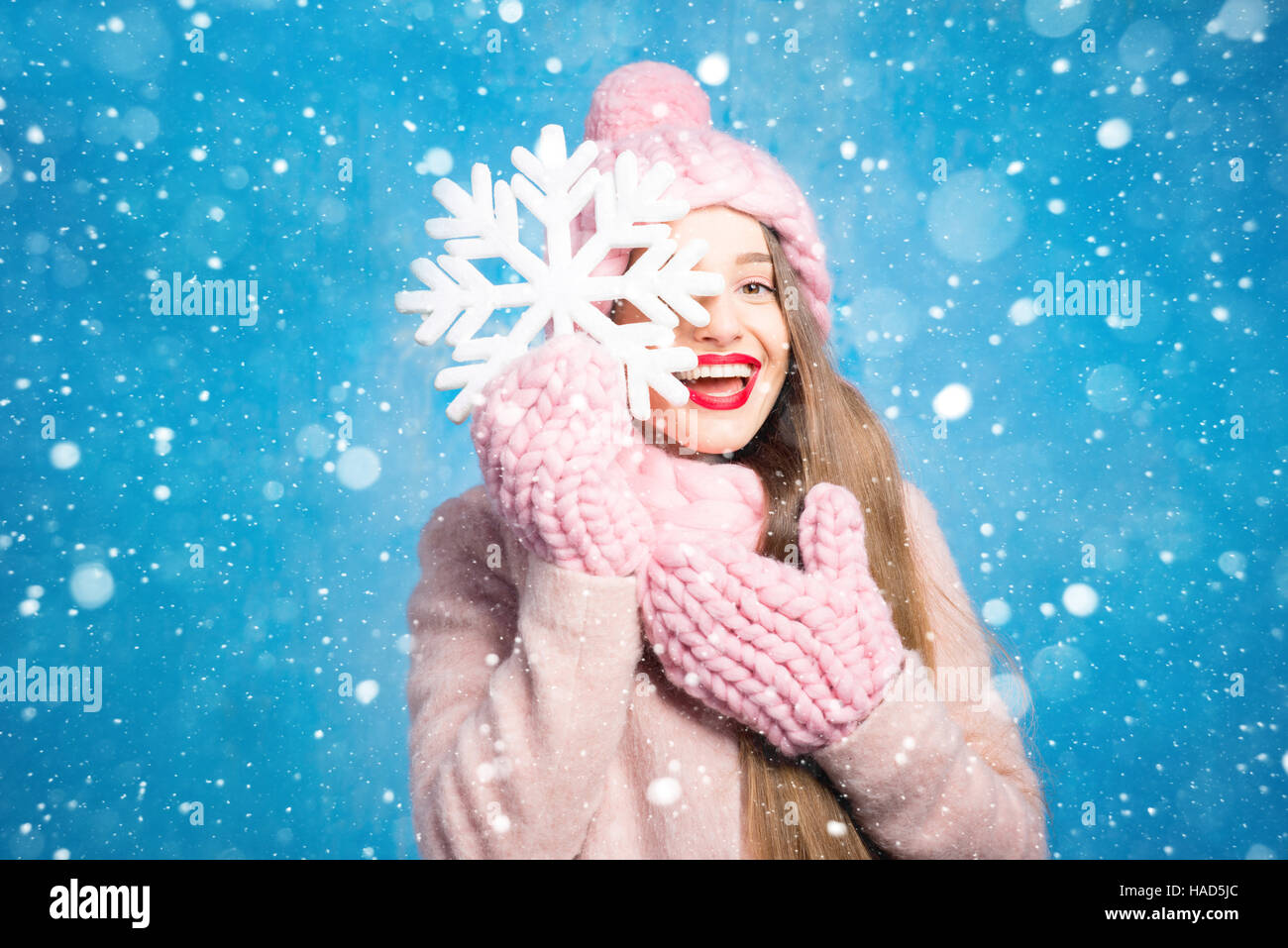 Winter woman portrait on the blue background Stock Photo - Alamy