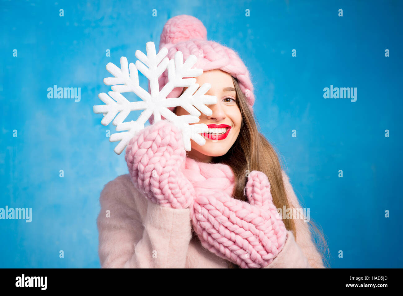 Winter woman portrait on the blue background Stock Photo - Alamy