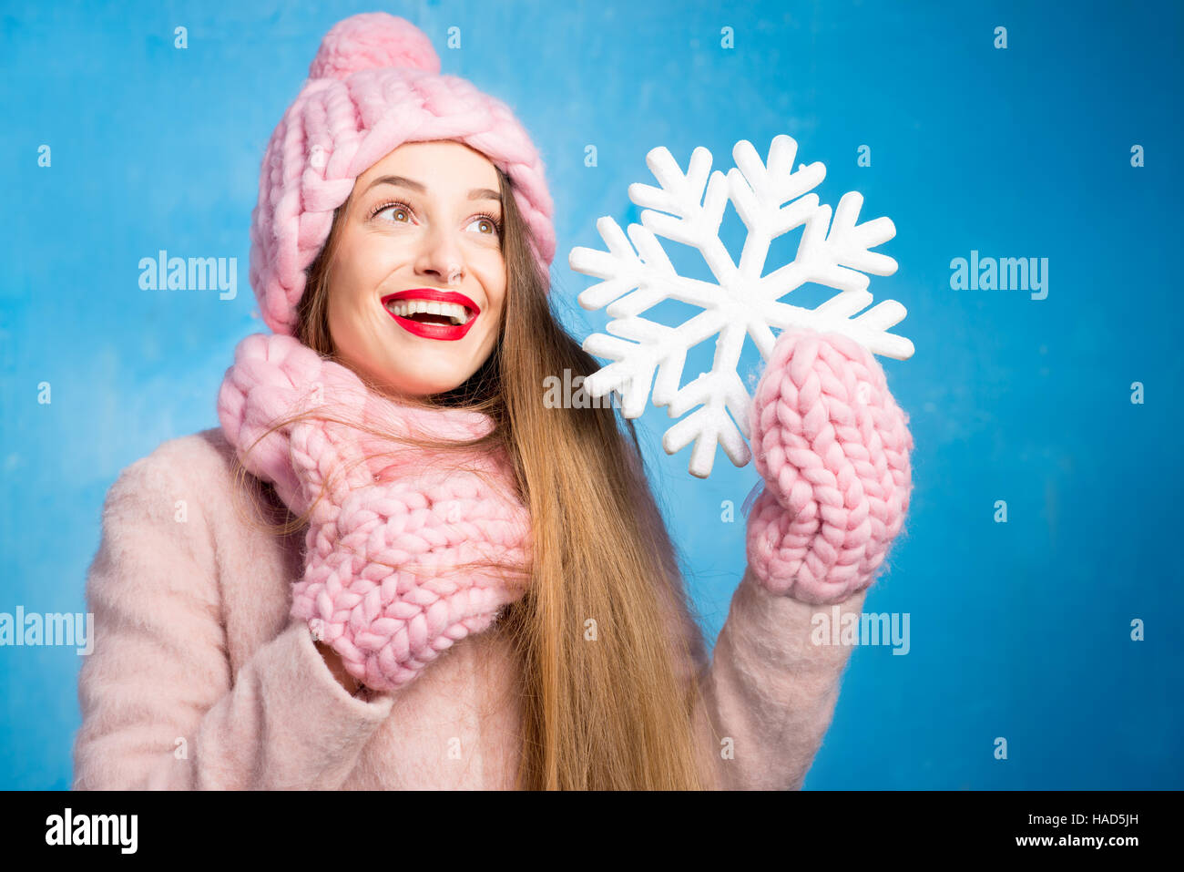 Winter woman portrait on the blue background Stock Photo - Alamy