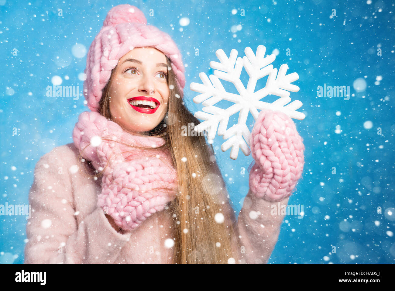 Winter woman portrait on the blue background Stock Photo - Alamy
