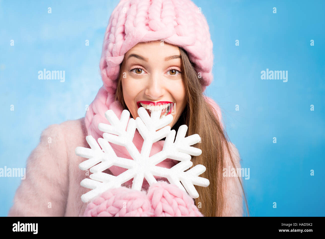 Winter woman portrait on the blue background Stock Photo - Alamy