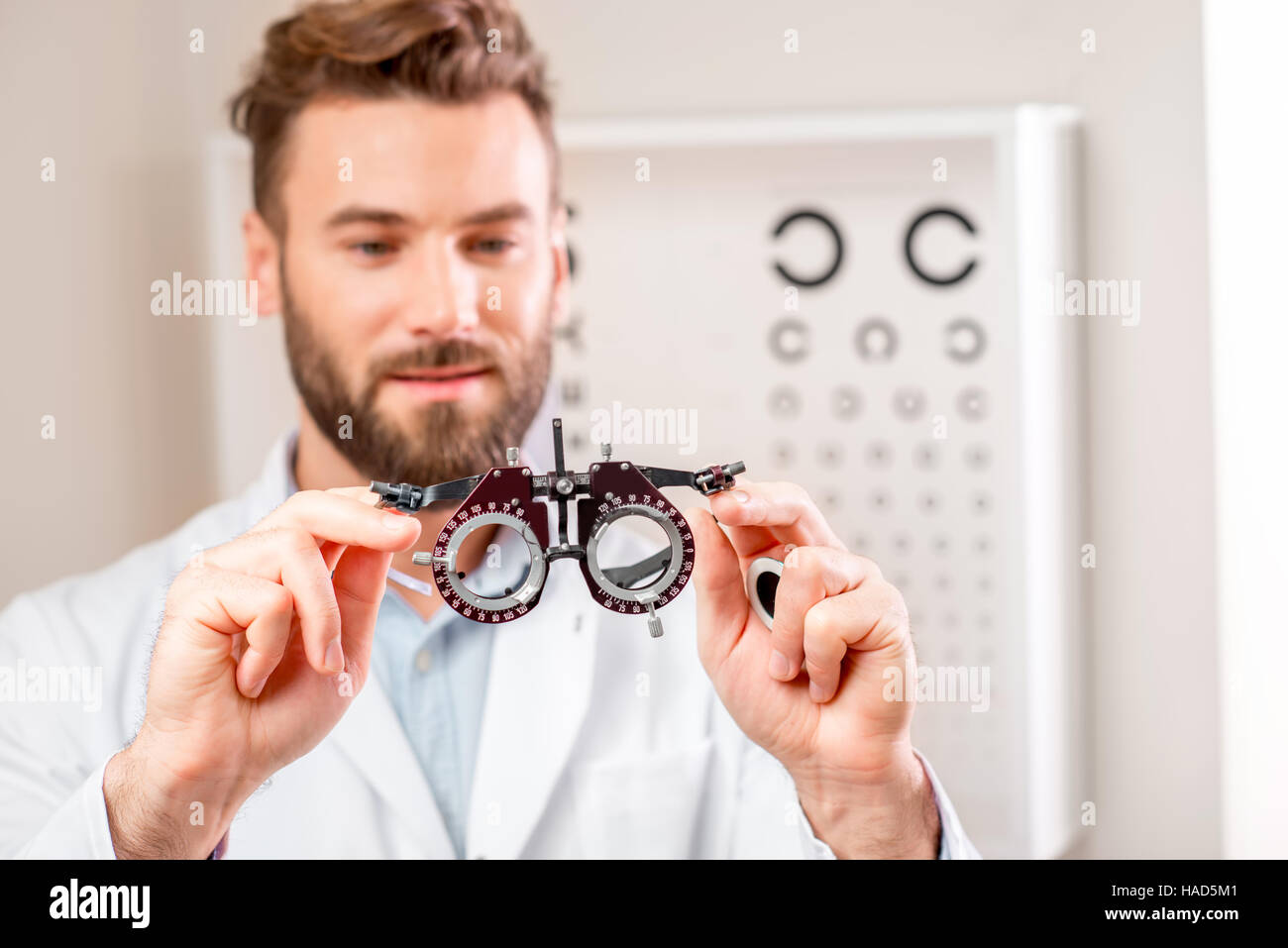 Oculist with try-on tool for lenses Stock Photo - Alamy