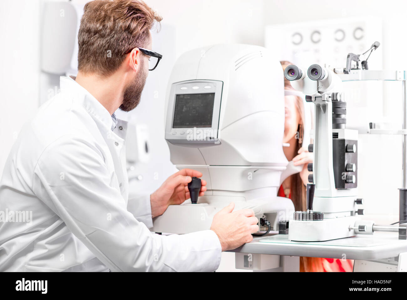 Female ophthalmologist checking male hi-res stock photography and ...