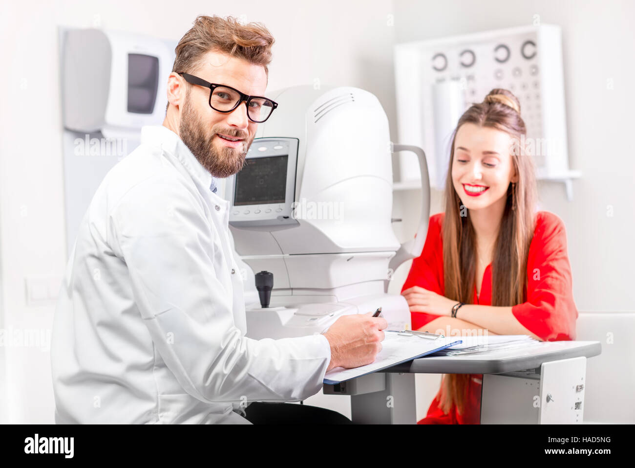 Eye doctor with patient Stock Photo - Alamy