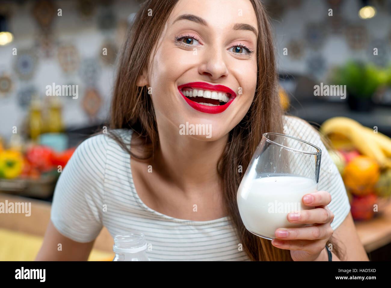 Woman with milk in the kitchen Stock Photo - Alamy