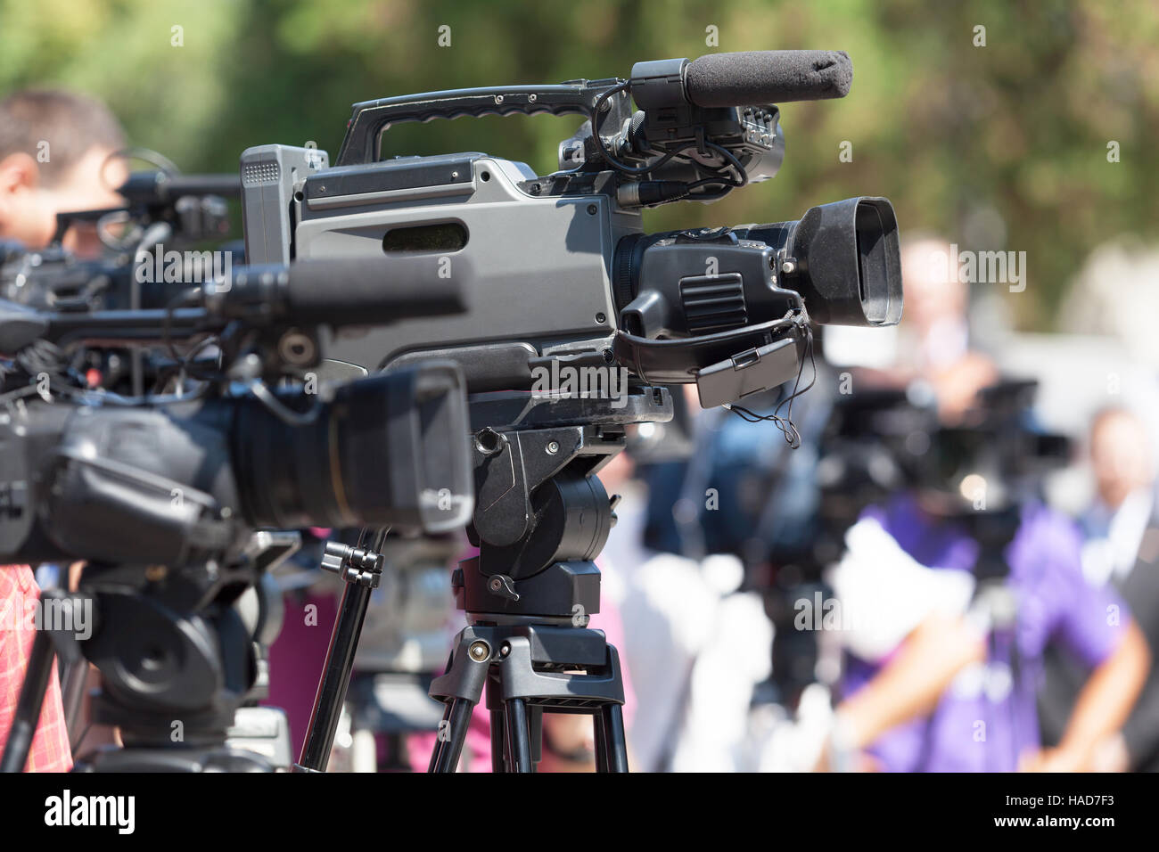 Filming an event with a video camera. News conference Stock Photo - Alamy