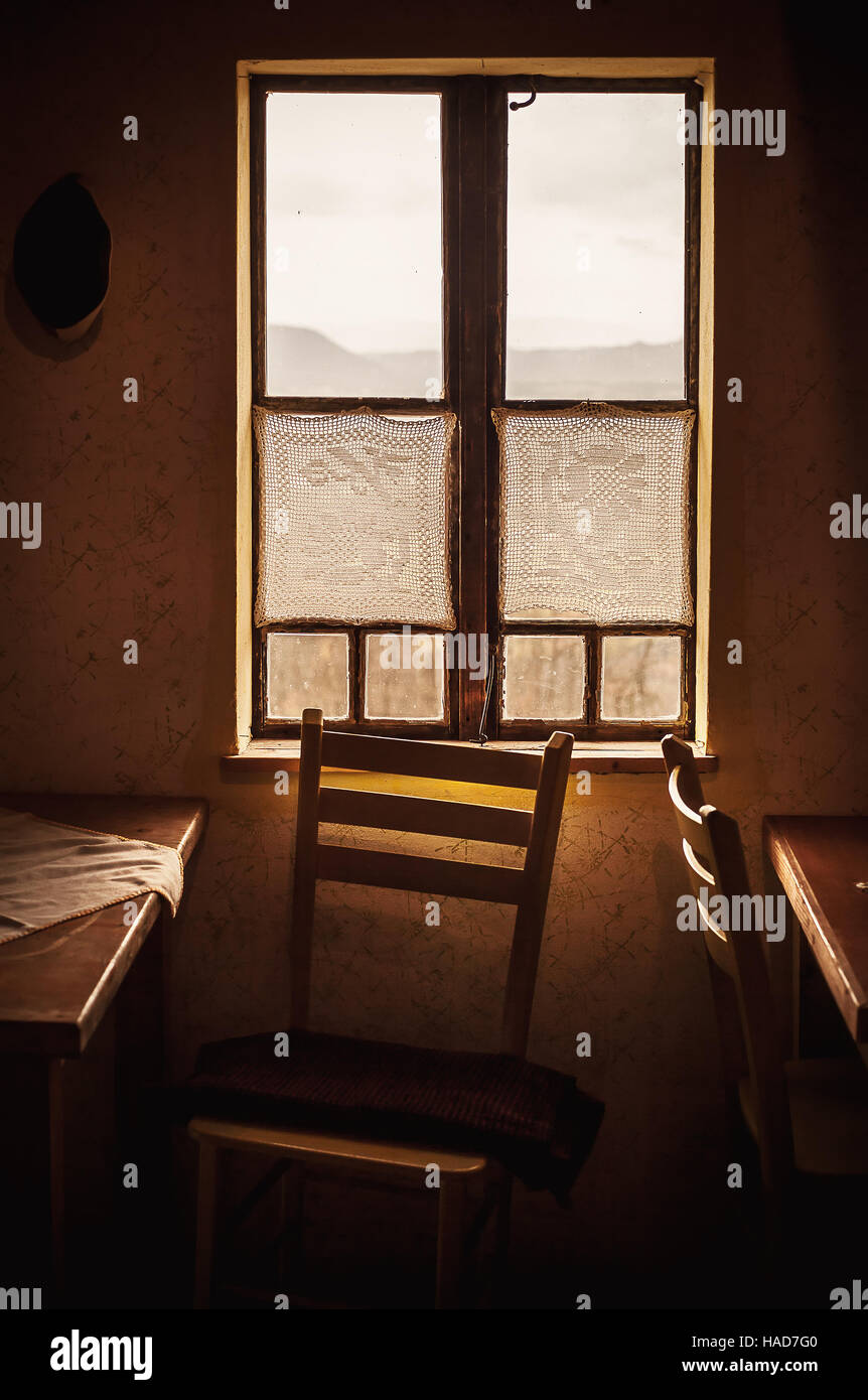 Closeup view of an old wooden window and chair in front of it Stock ...