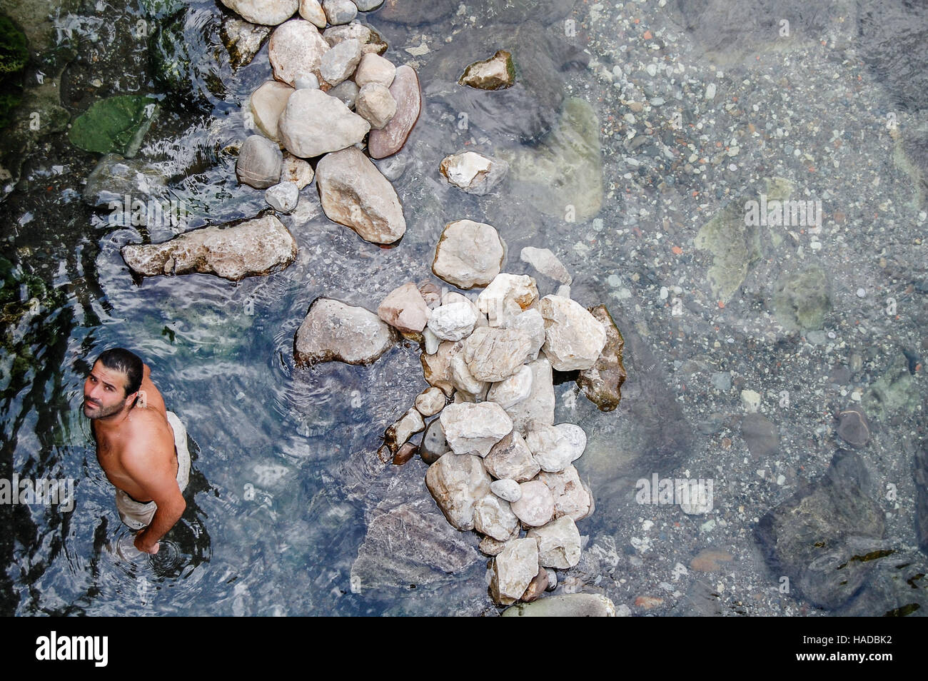 Young man enjoying a relaxing bath in the natural hot springs Stock ...