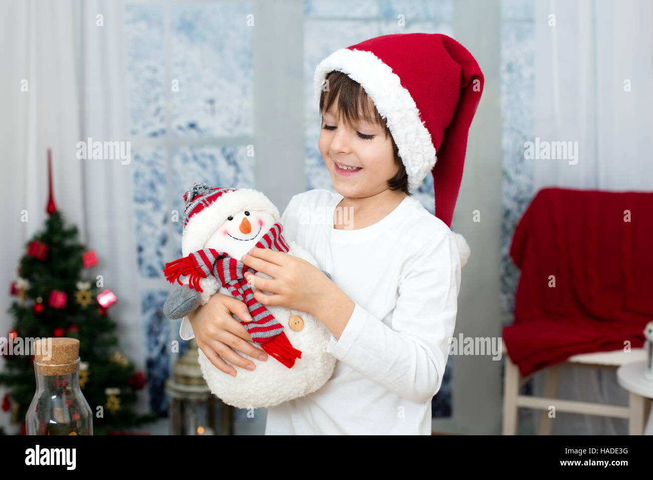 Christmas portrait of cute little preschool boy, eating cookies and ...