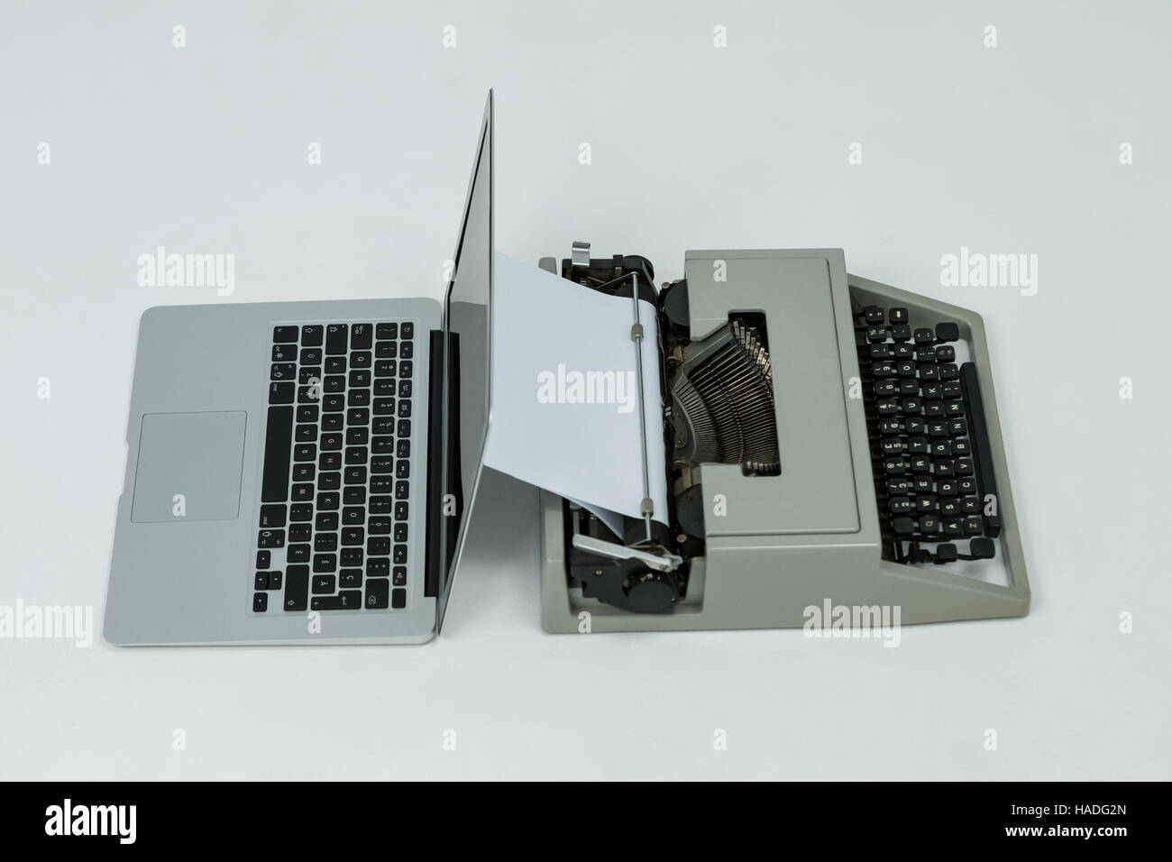 Laptop and typewriter on white background Stock Photo - Alamy
