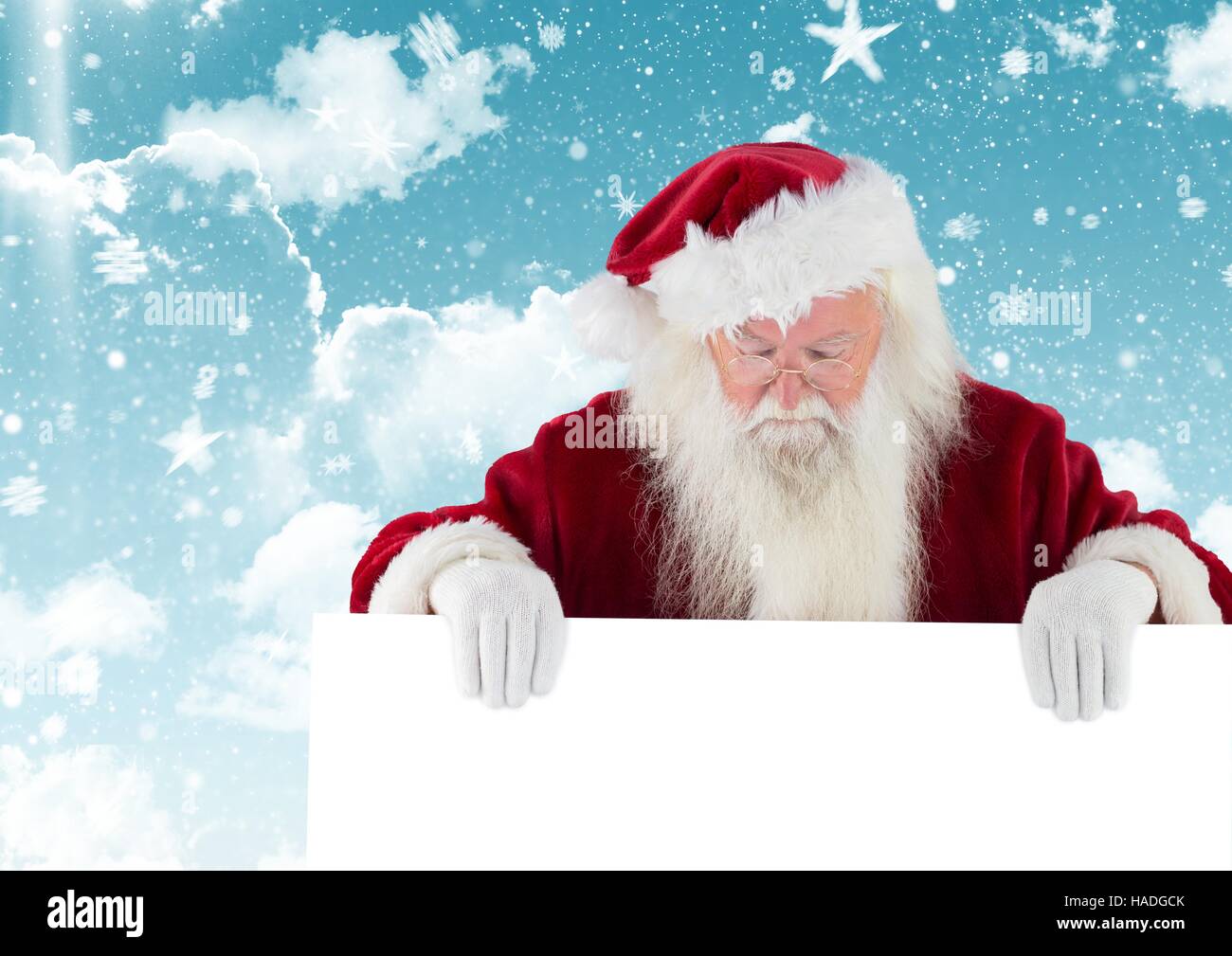 Santa claus looking down at white placard Stock Photo - Alamy