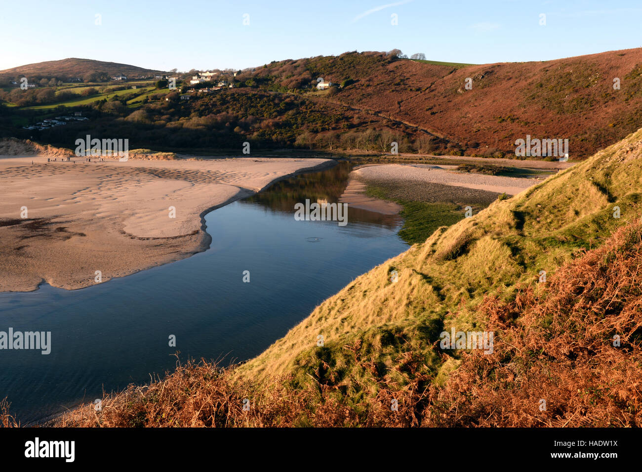 Three cliffs bay at Penmaen. A high tide fills the valley with the ...