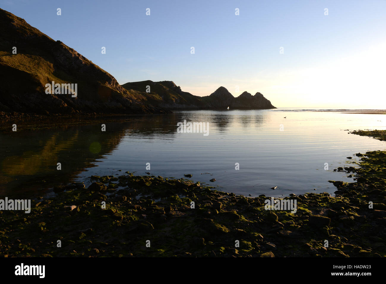 Three cliffs bay, Gower, Wales at sunset . A high tide fills the valley ...
