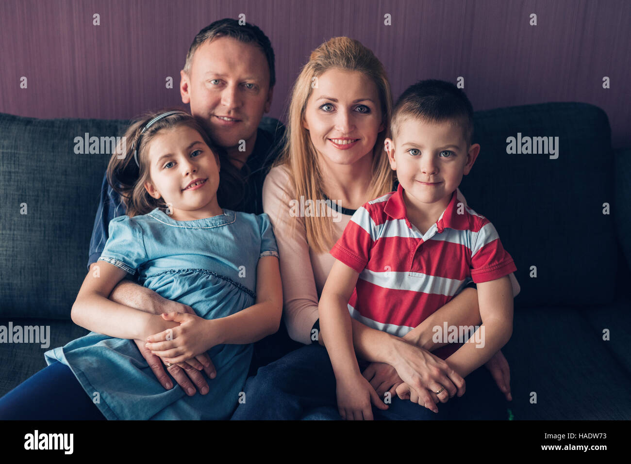 Happy family of four at home Stock Photo - Alamy