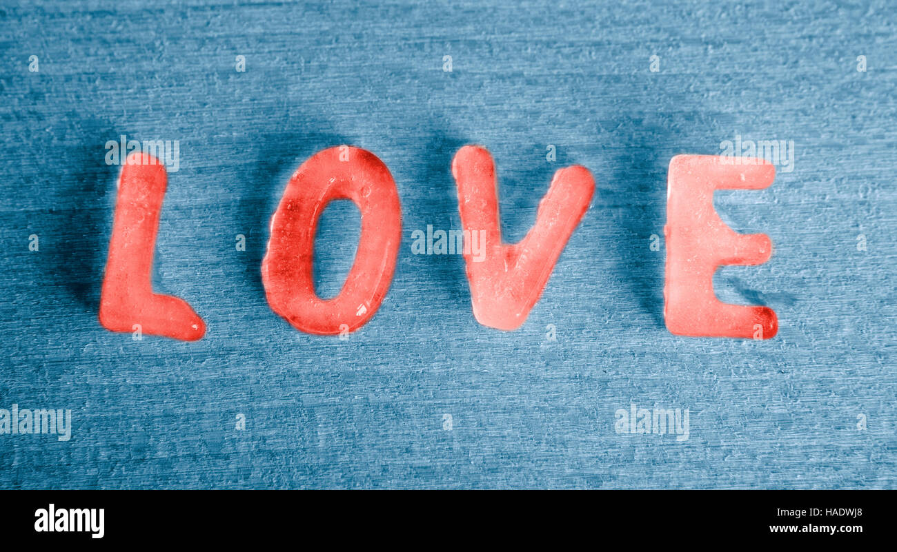 the word Love as red ice cubes on blue background Stock Photo - Alamy