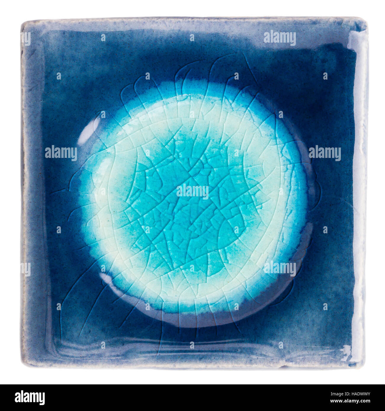 Blue handmade glazed ceramic tile with a dot in middle isolated on ...