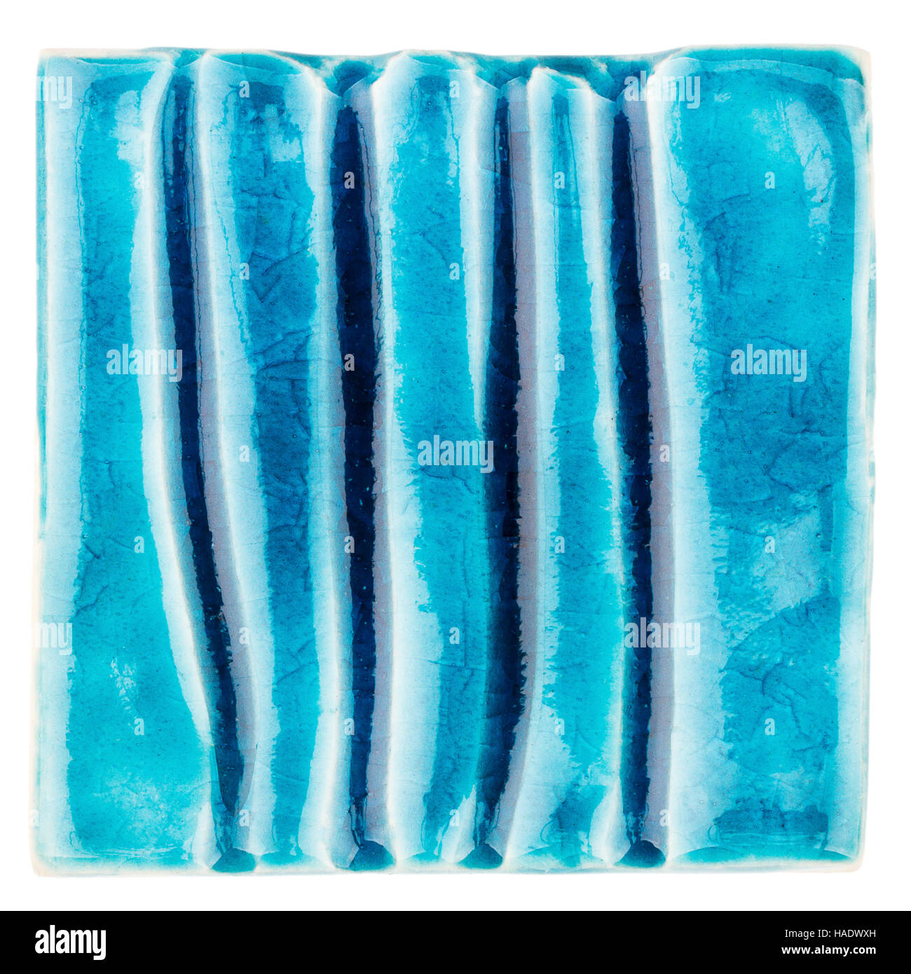 Blue lined handmade glazed ceramic tile isolated on white background ...