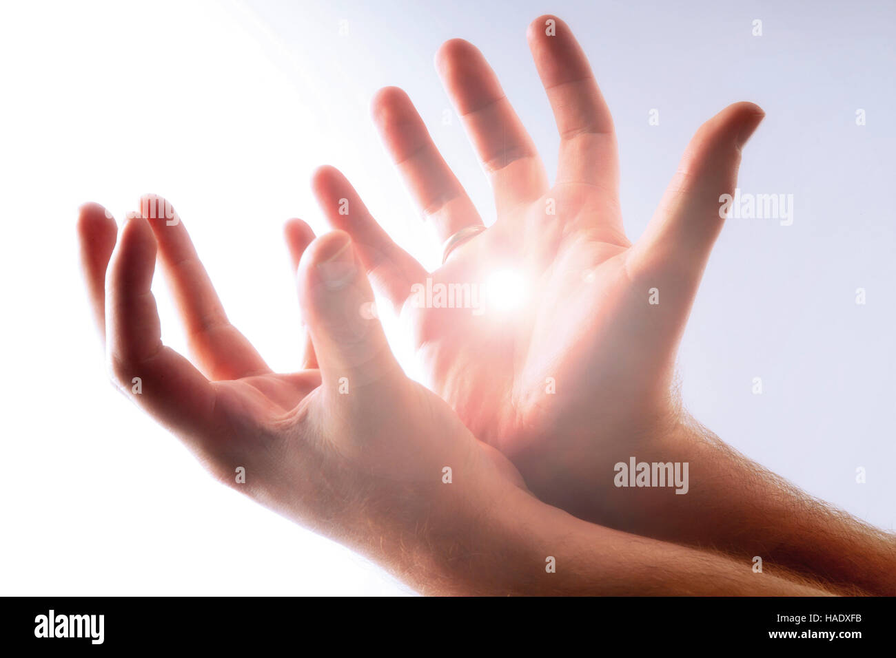 Hands seeking help in gleaming light Stock Photo - Alamy