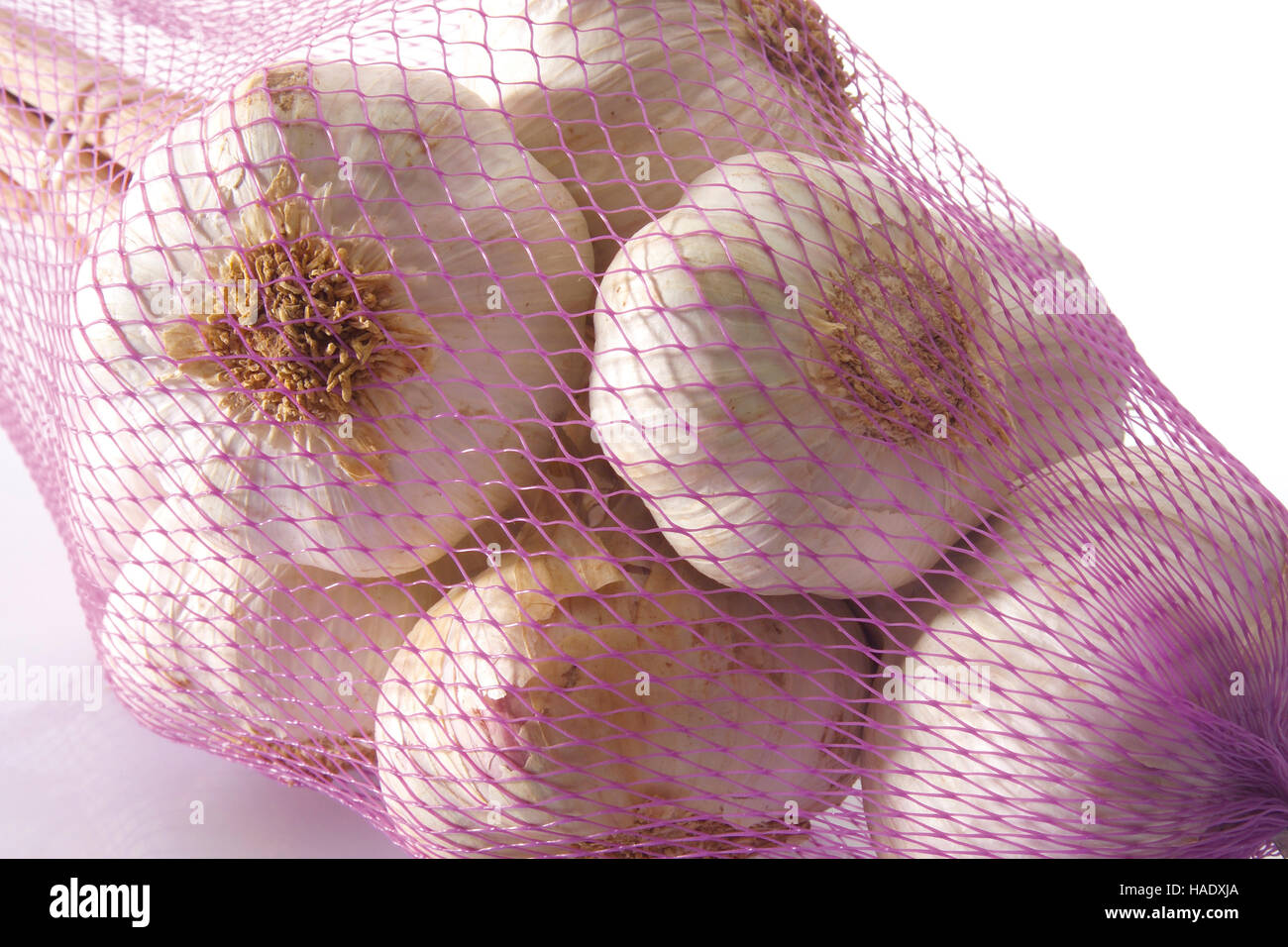 Cloves of garlic in net bag Stock Photo - Alamy