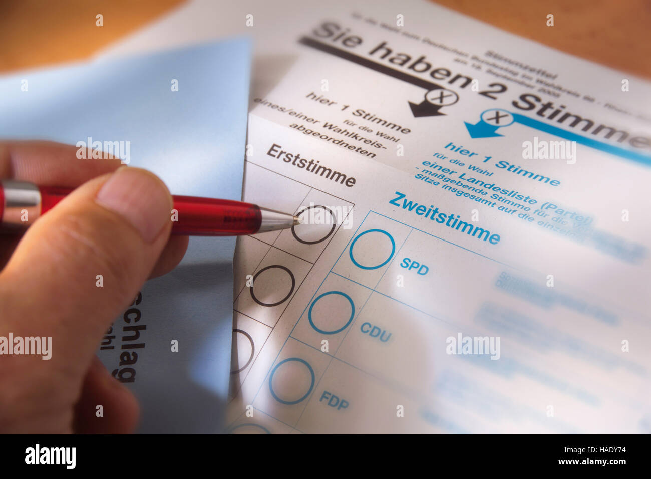 Ballot paper, hand with pen Stock Photo - Alamy