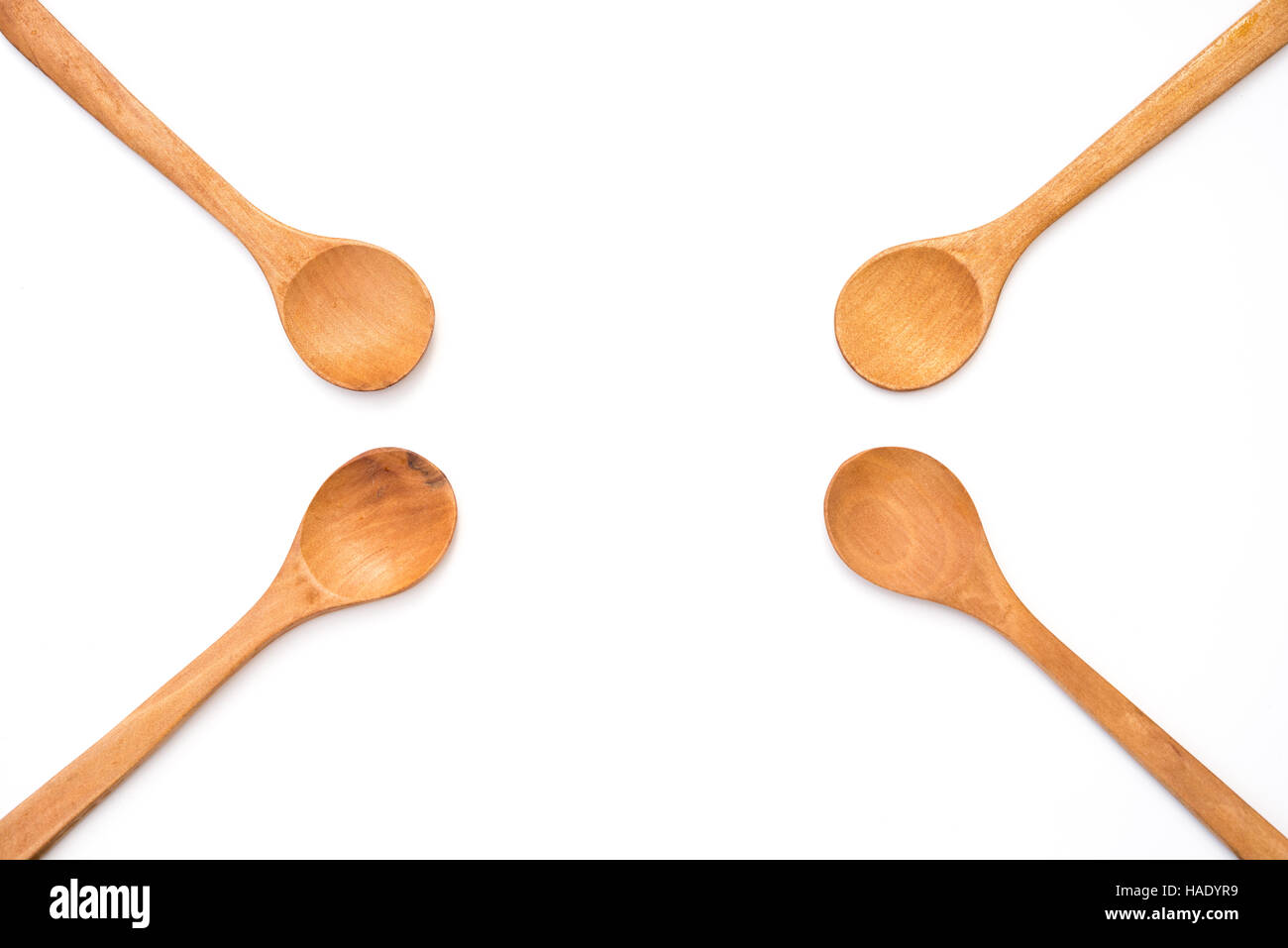 four empty wooden spoons on white background Stock Photo - Alamy