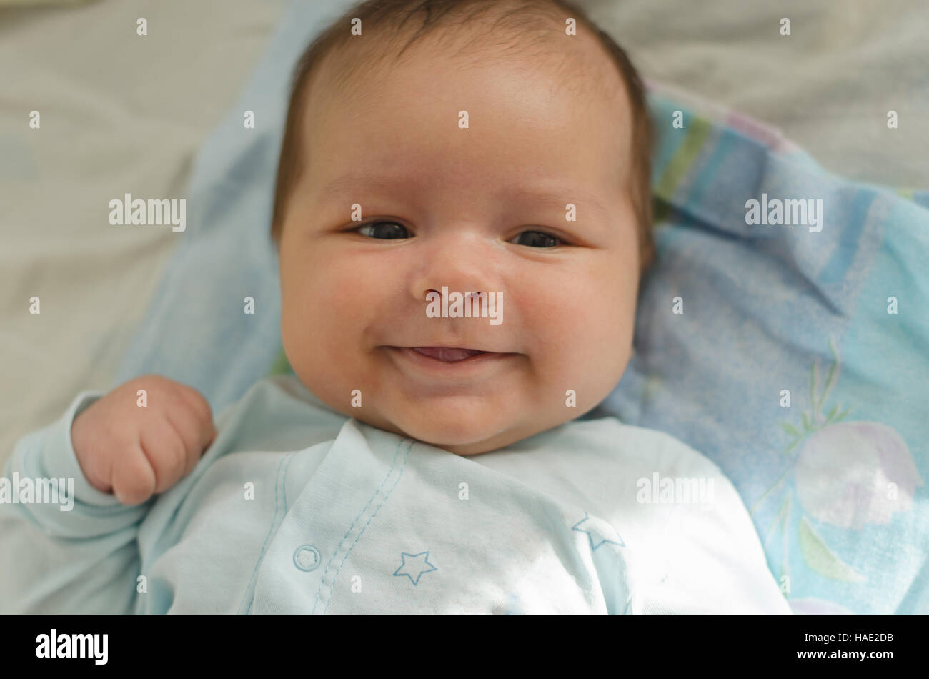 Beautiful newborn baby smiling and laughing. Soft focus Stock Photo - Alamy