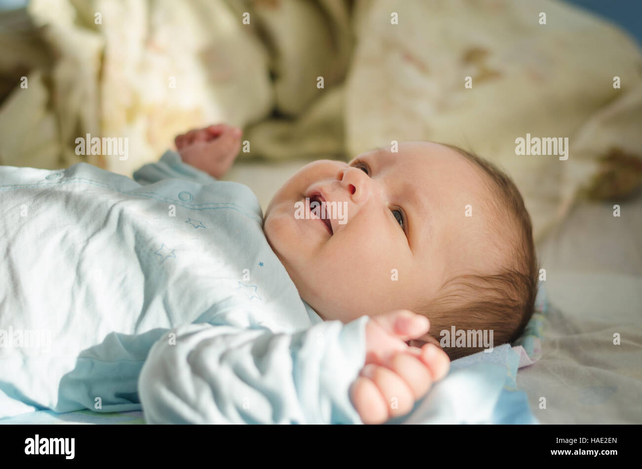 Beautiful newborn baby smiling and laughing. Soft focus Stock Photo - Alamy